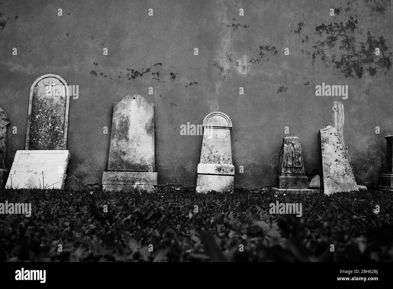 Abandoned cemetery old cement gravestones laying around Stock Photo - Alamy