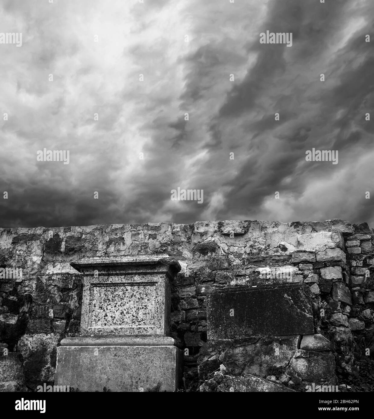 Gravestones with dramatic clouds scene behind Stock Photo - Alamy