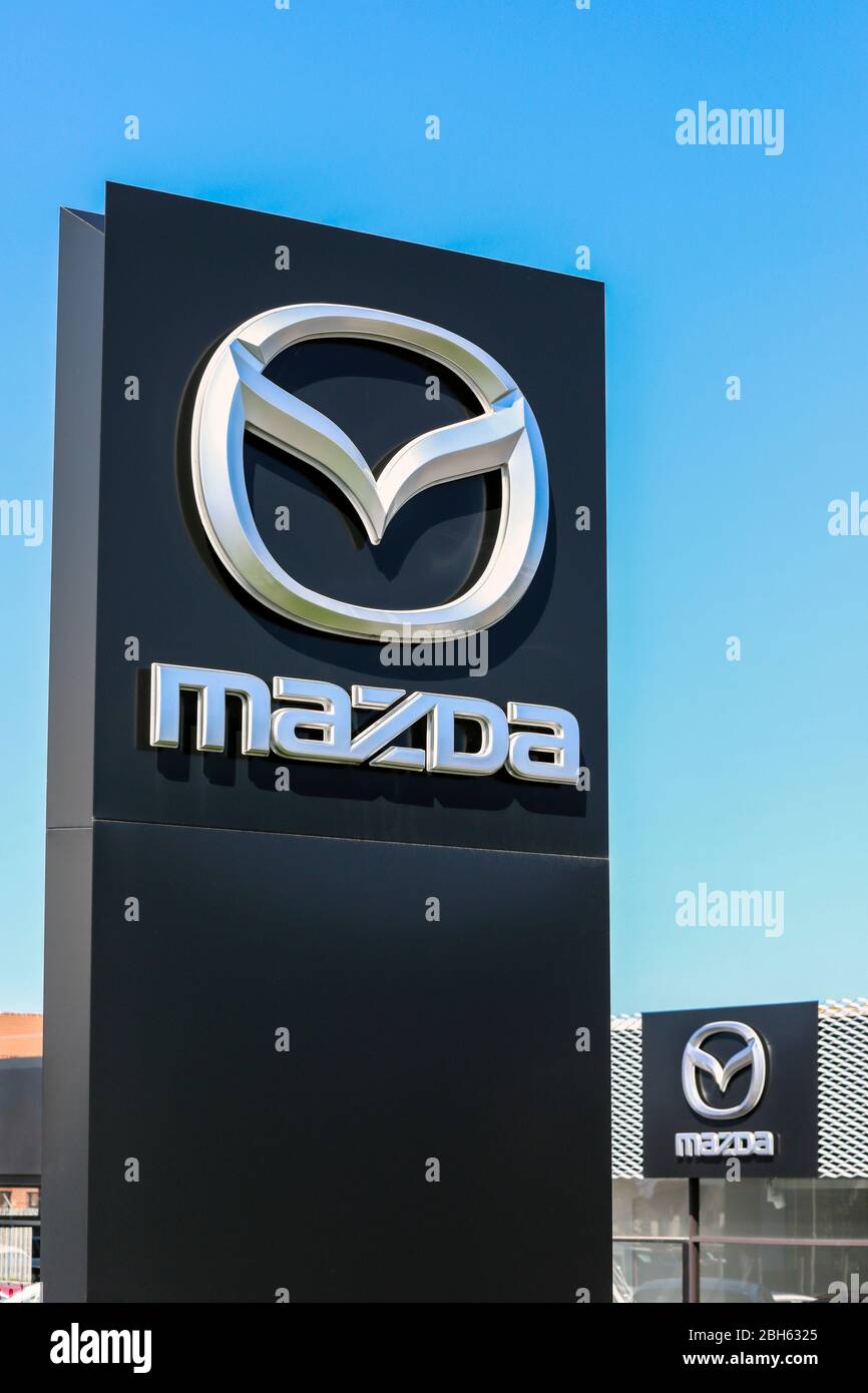 Logo sign for Mazda motors, outside a vehicle outlet, Ayr Stock Photo ...
