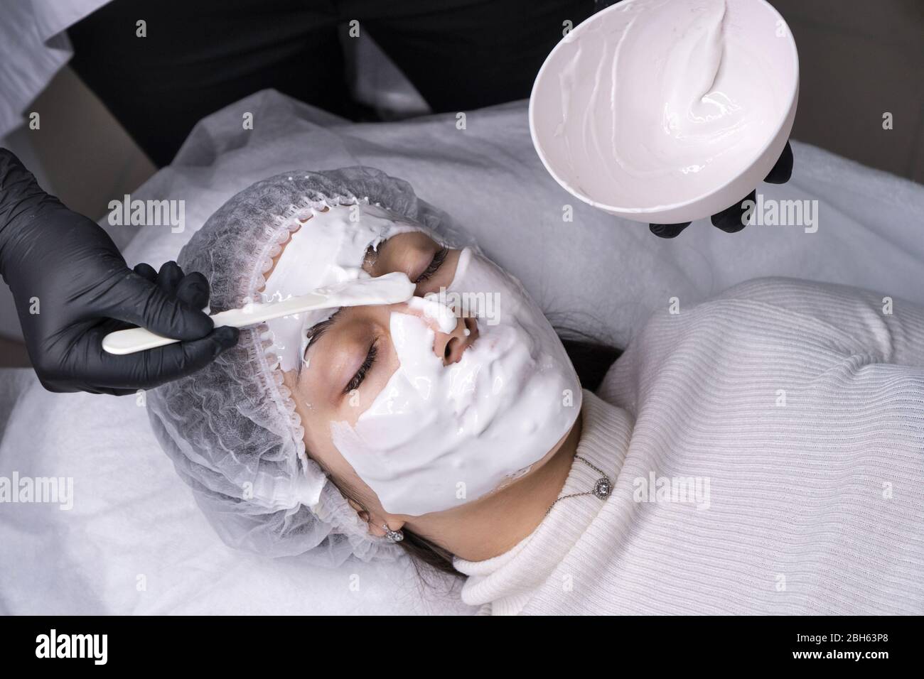 Beautician applies alginate mask hi-res stock photography and images ...