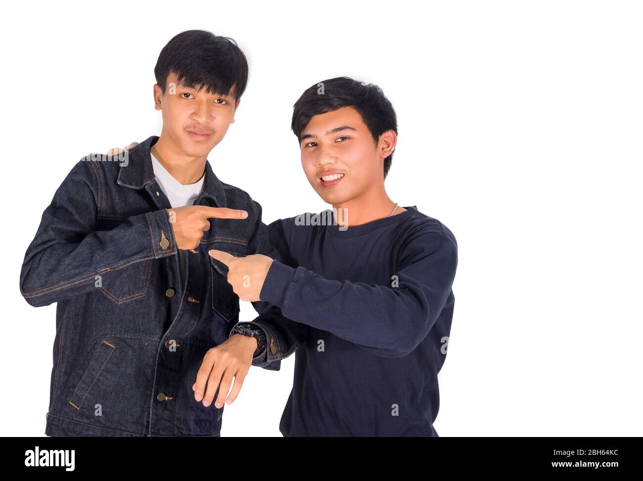 Two Asian boys are pointing to each other white background Stock Photo ...