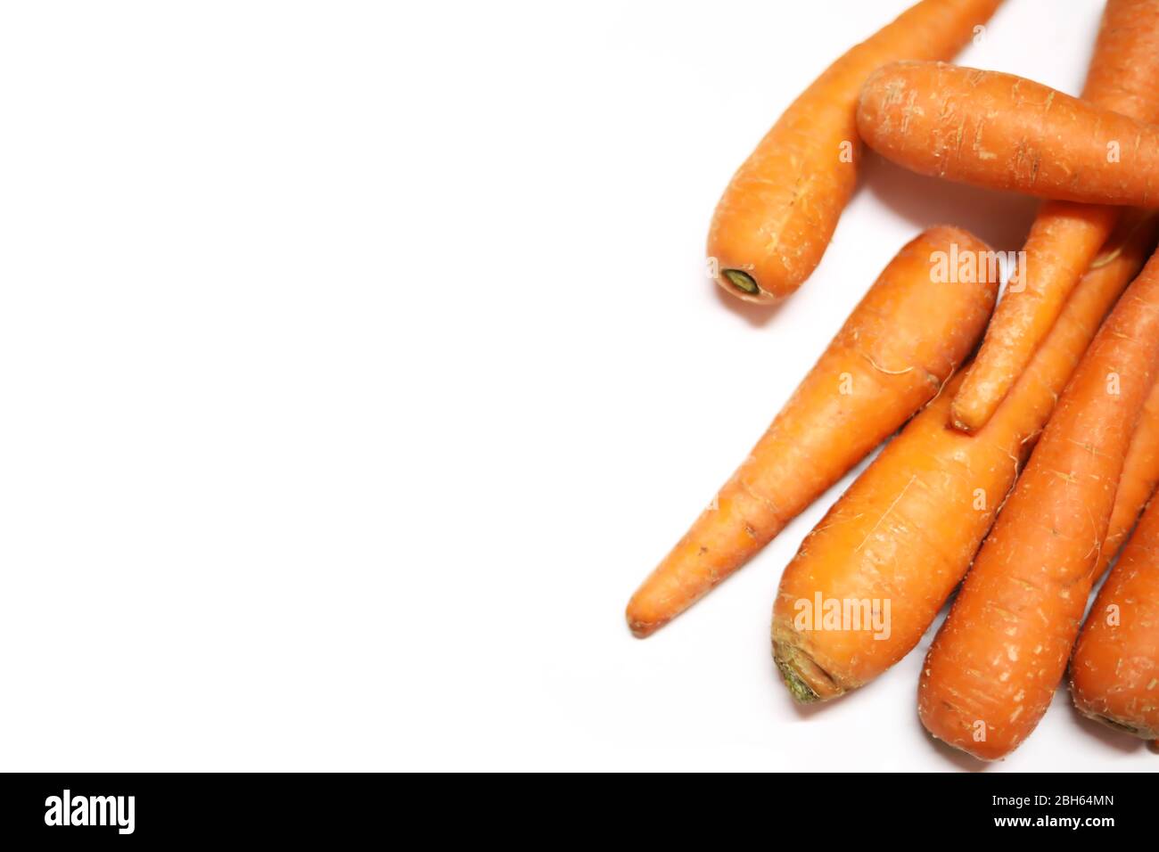 Fresh carrots on a white background. Top view Stock Photo - Alamy