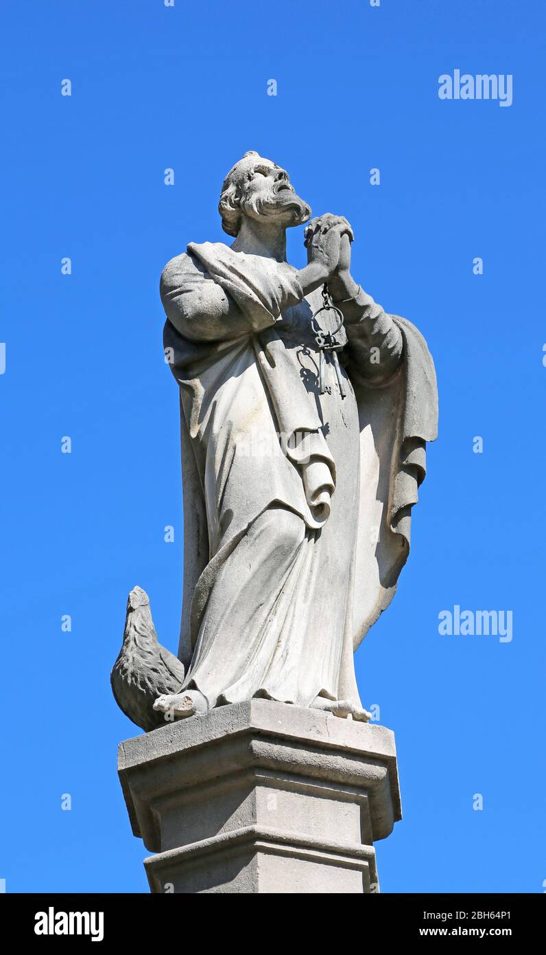 Statue of a man praying in the yard of St Peter's Monastery in Salzburg ...