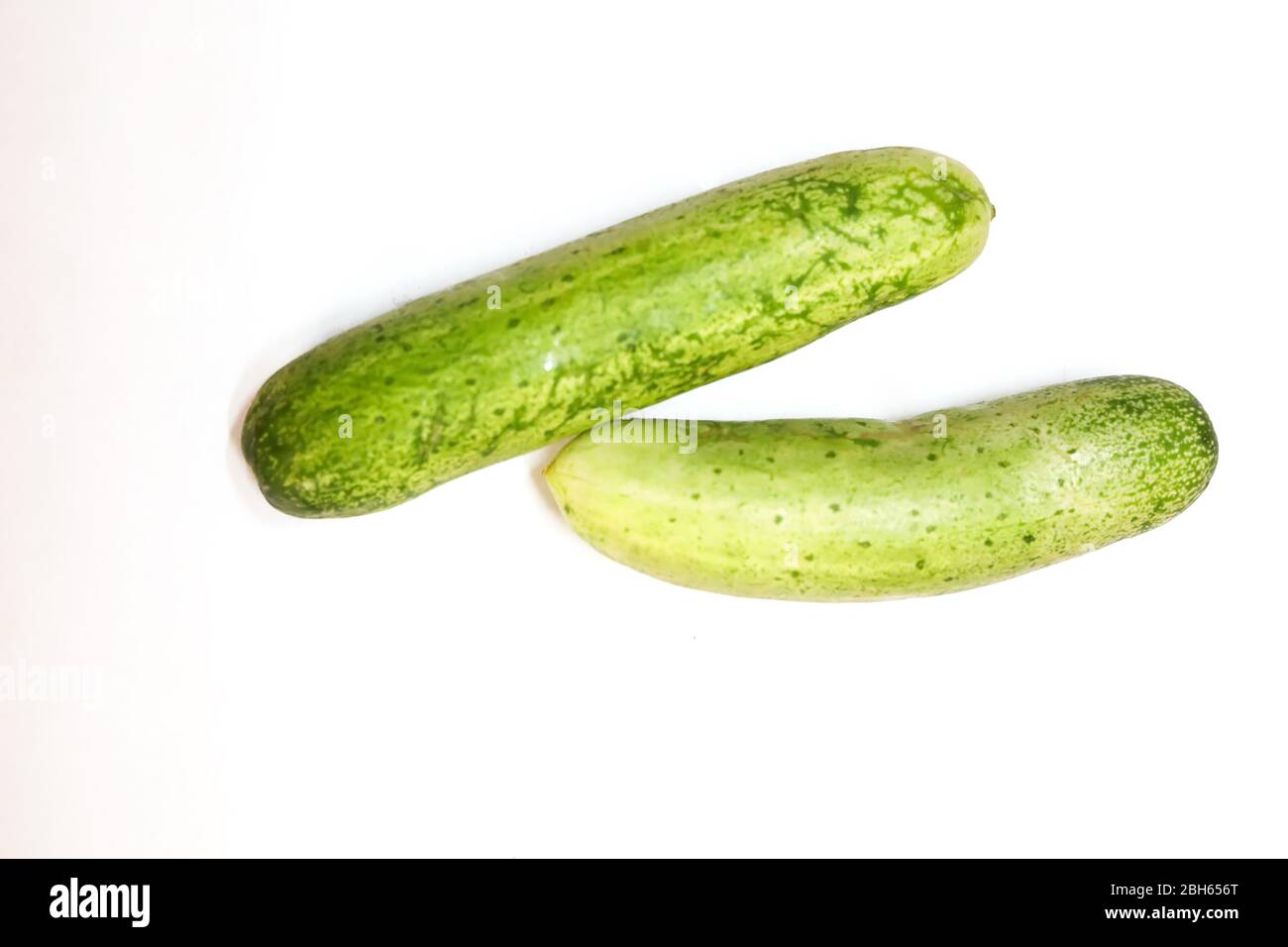 Two cucumbers on an isolated white backgrounds Stock Photo - Alamy