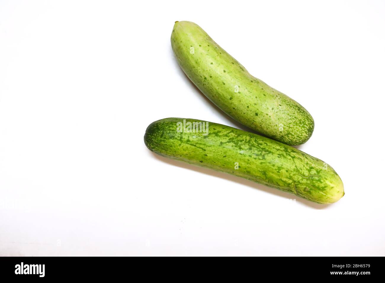 Two cucumbers on an isolated white background Stock Photo - Alamy