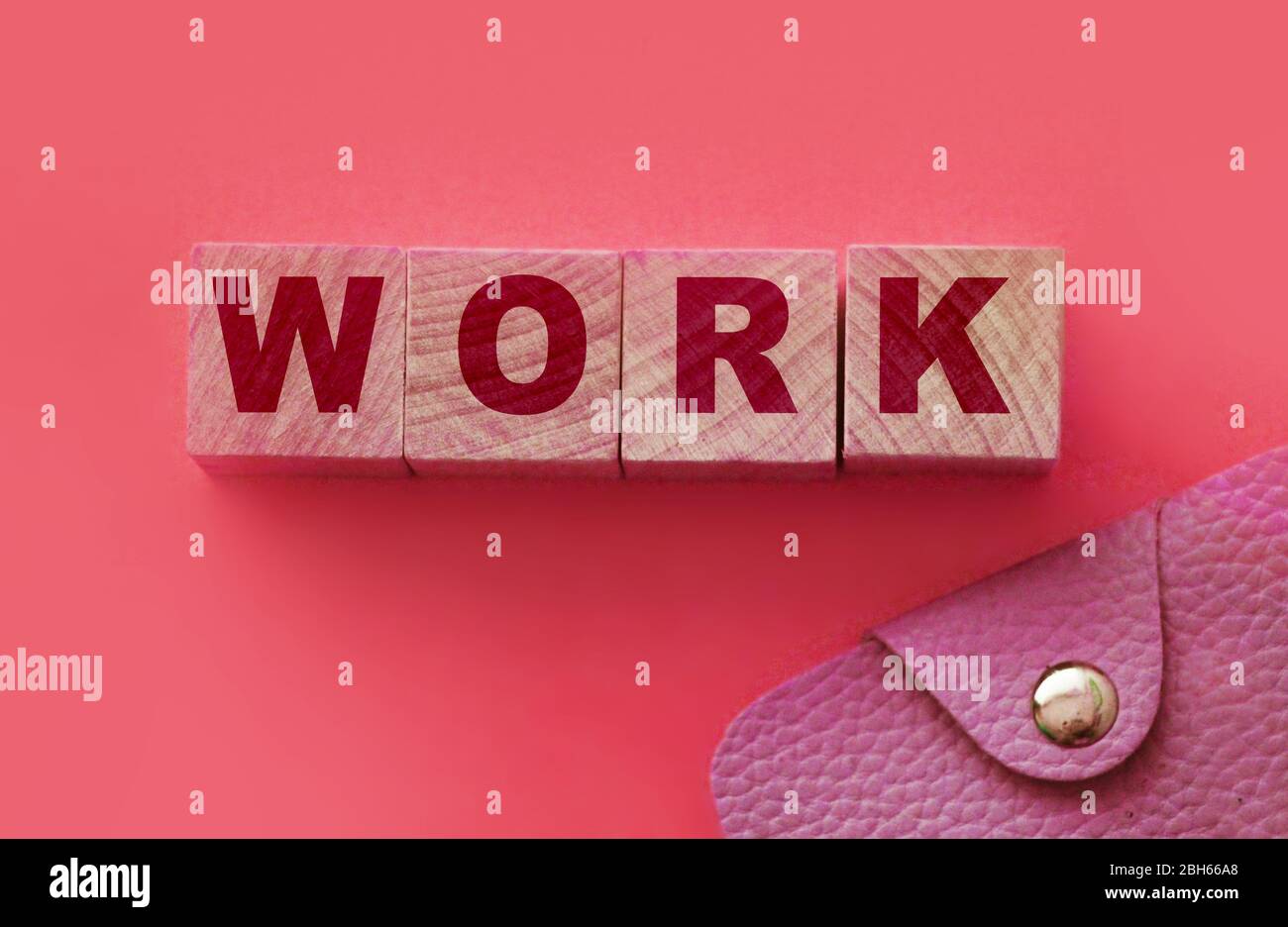 Workword made with wooden blocks and wallet on pink . Job salary money ...