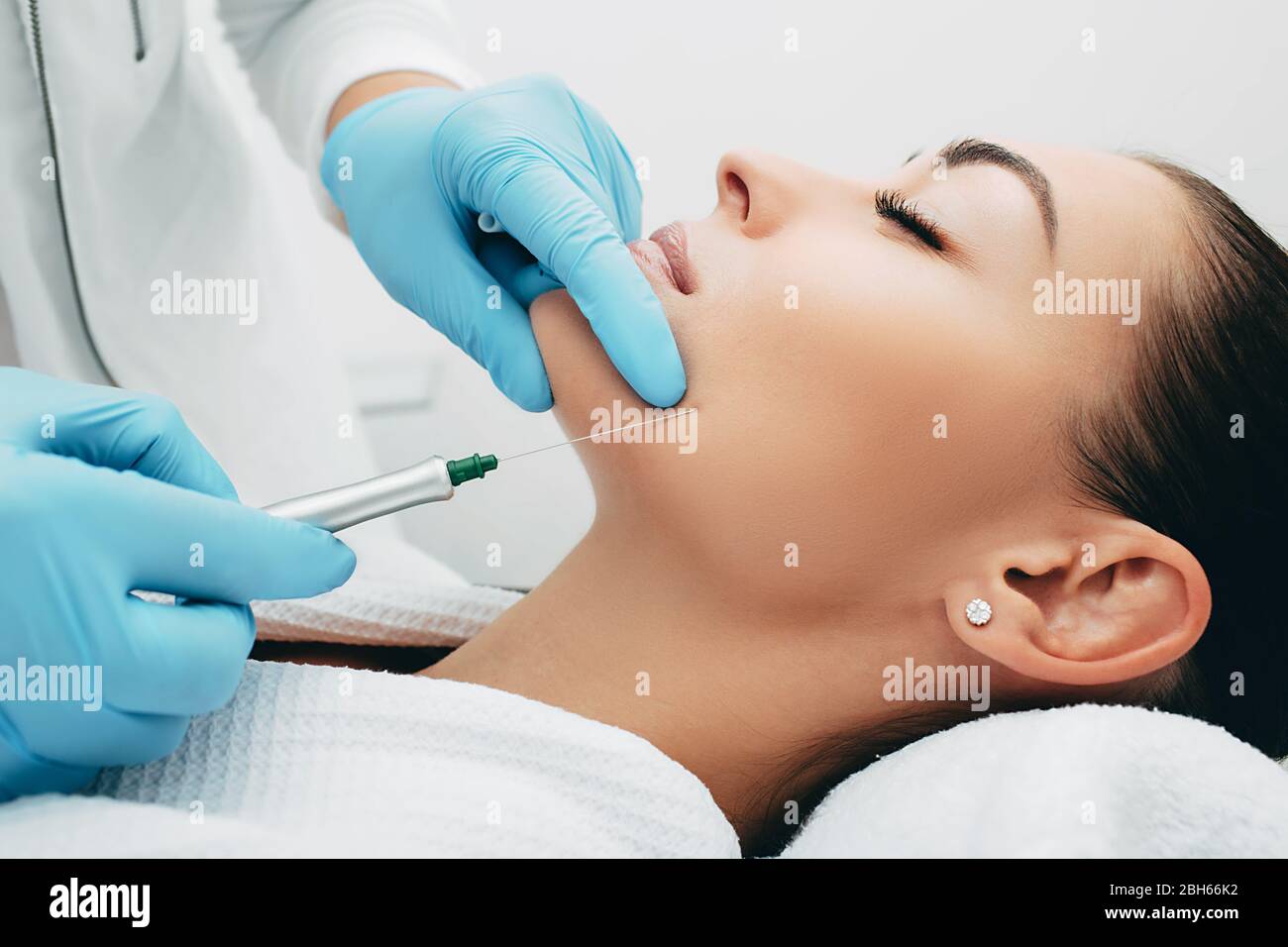 woman having facial injections for facelift and anti-aging effect ...