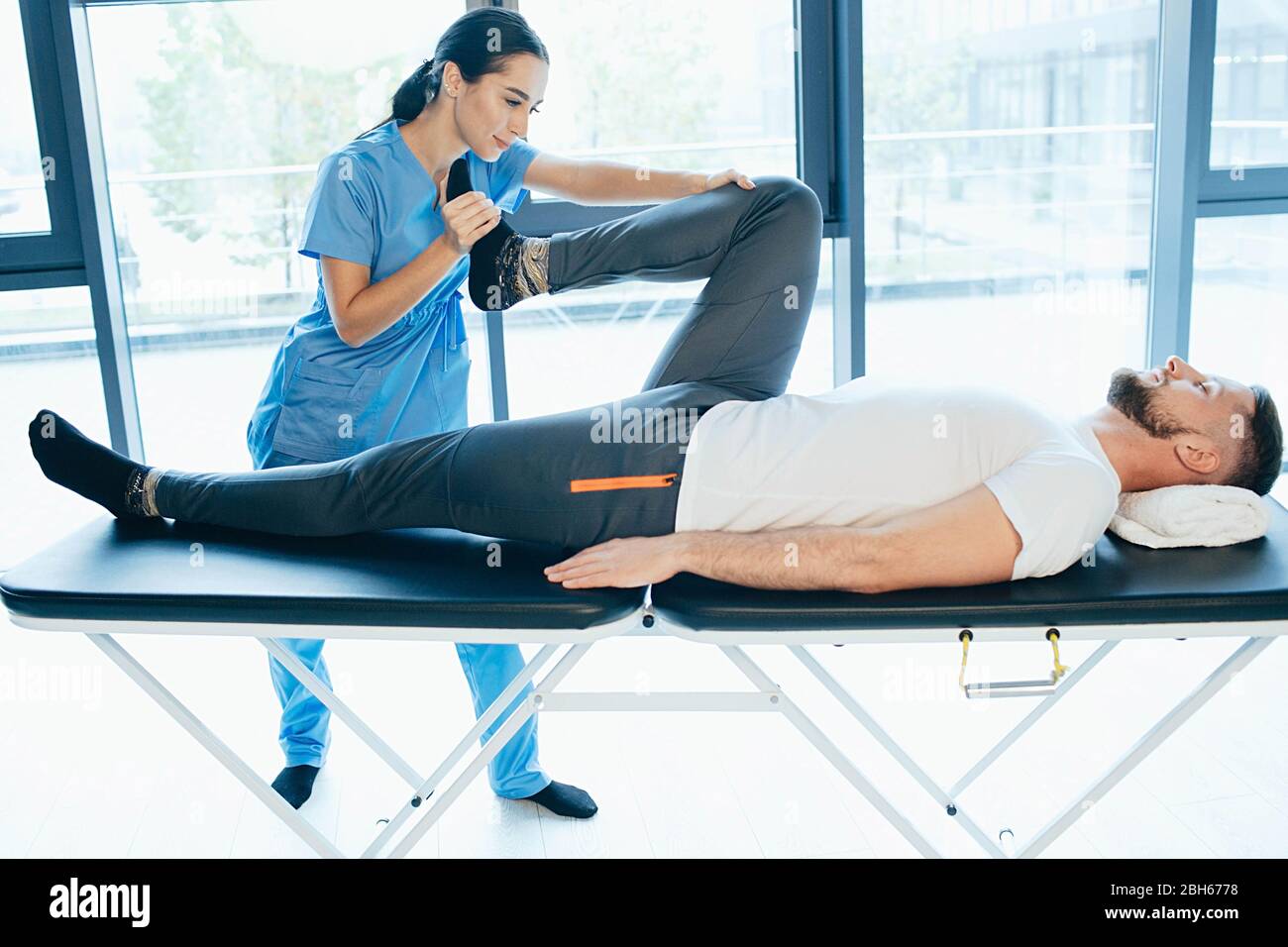 man treat lumbar disc. man lying on massage table while his physical ...