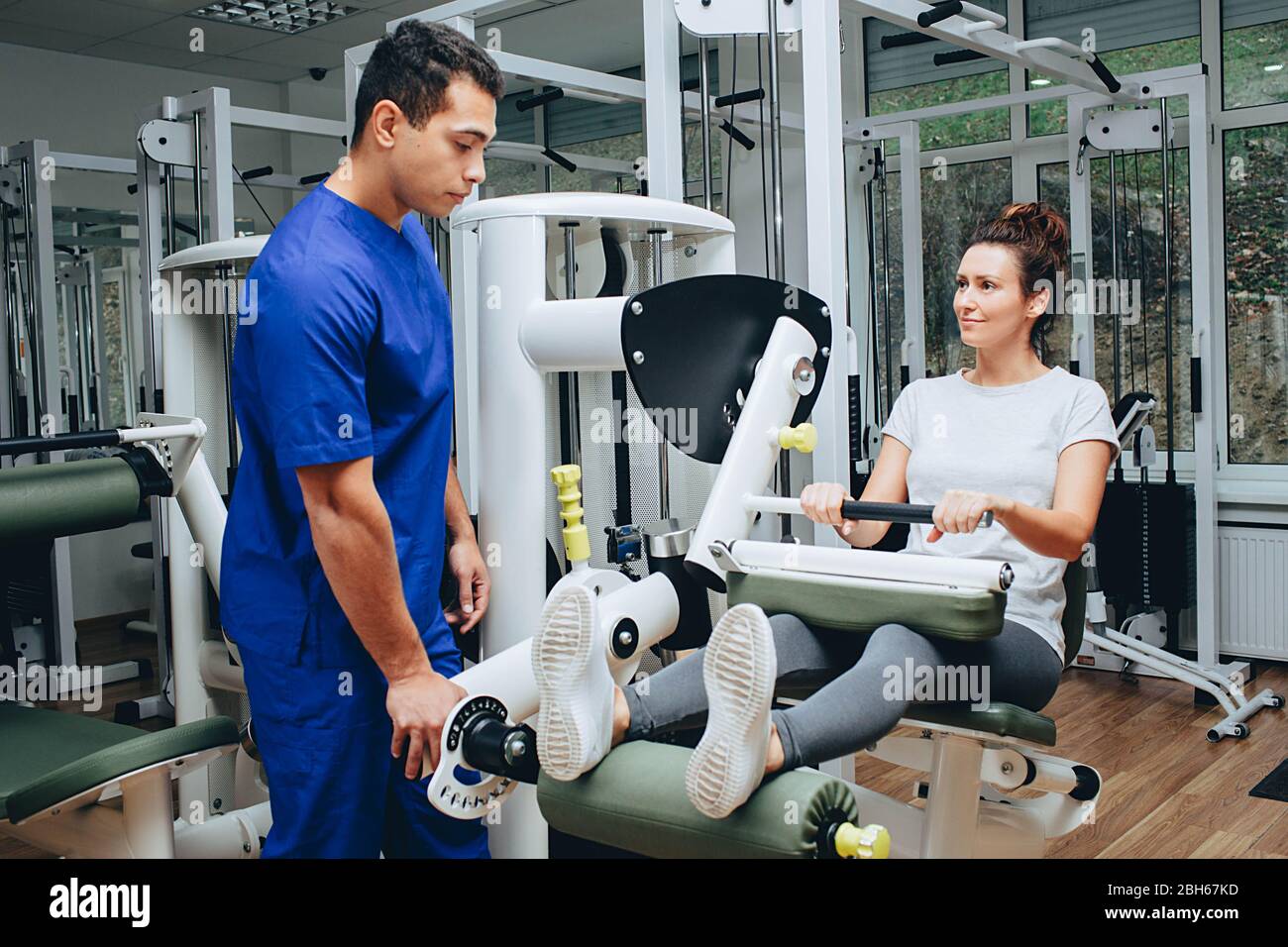 Rehabilitation specialist shows the patient how correctly doing ...