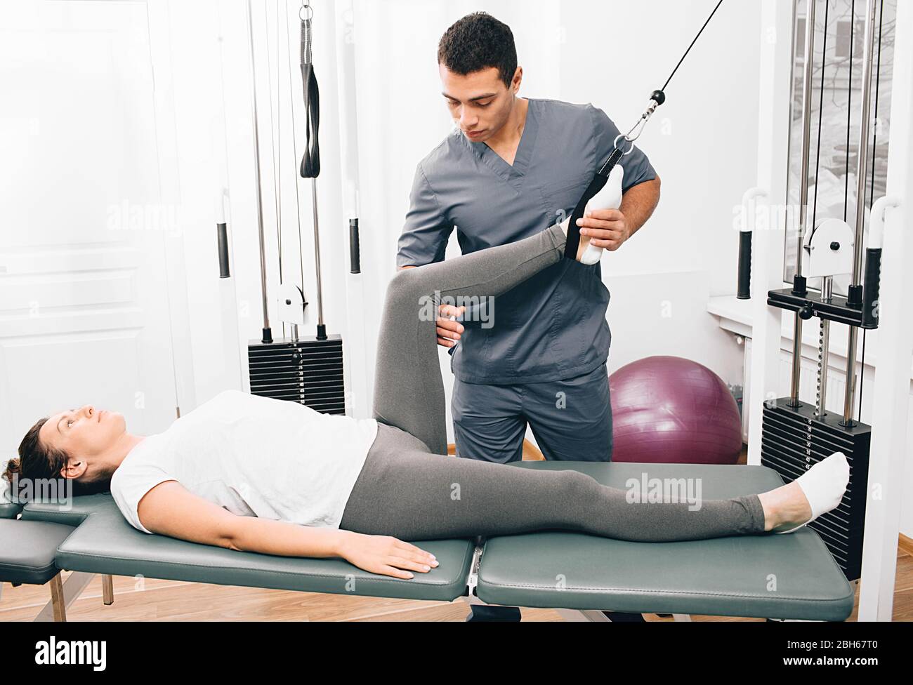 kinesiologist doing therapeutic exercises for a woman. Kinesitherapy at ...