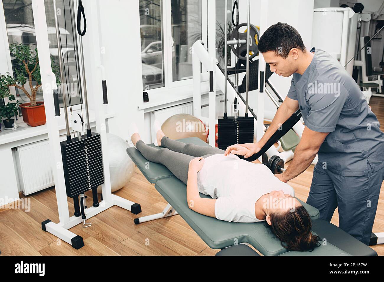 Kinesitherapy, exercises. Kinesiologist trains with the patient ...