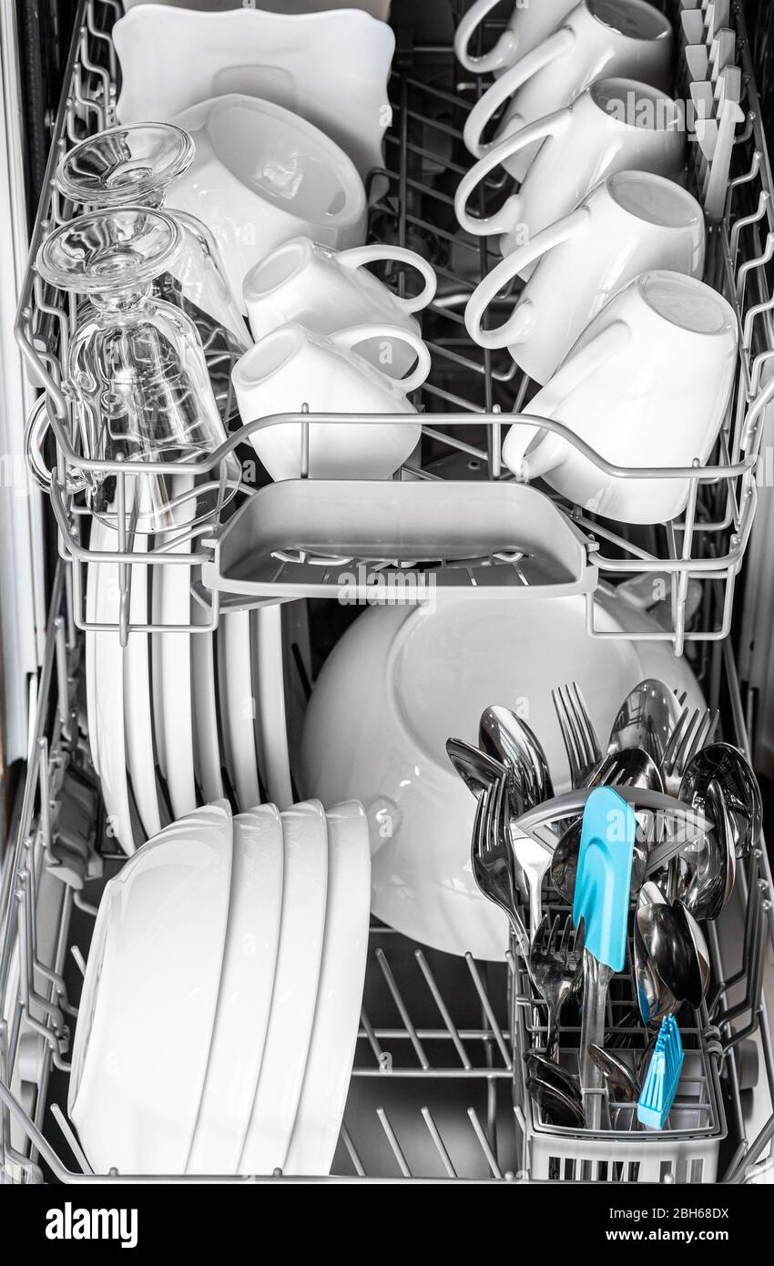 Clean dishes in a dishwasher basket close-up. Many clean and fresh ...