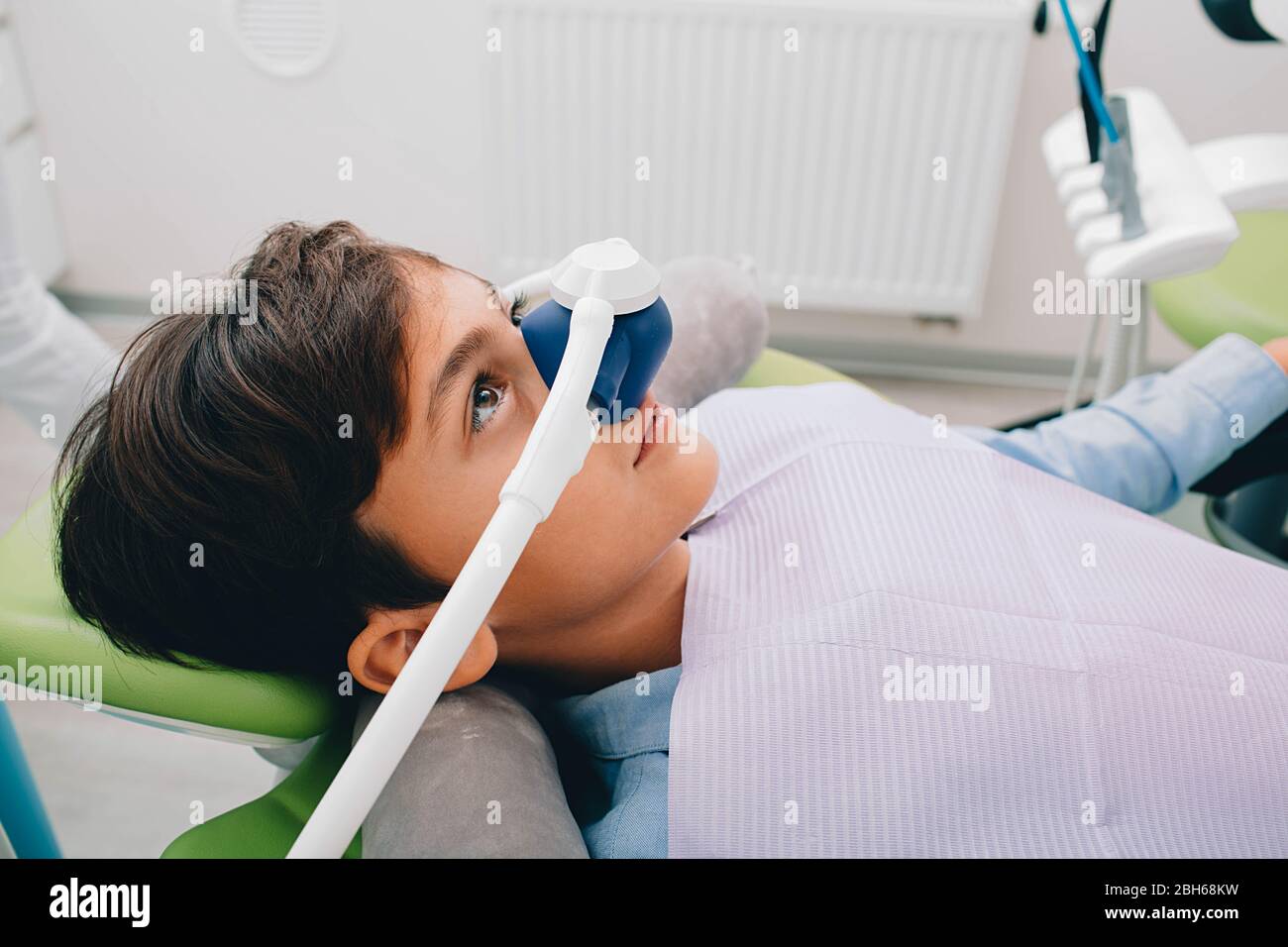 Little boy getting Inhalation Sedation while teeth treatment at dental ...