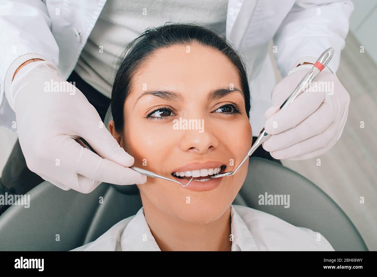Woman getting teeth exam with her dentist at dental clinic Stock Photo ...