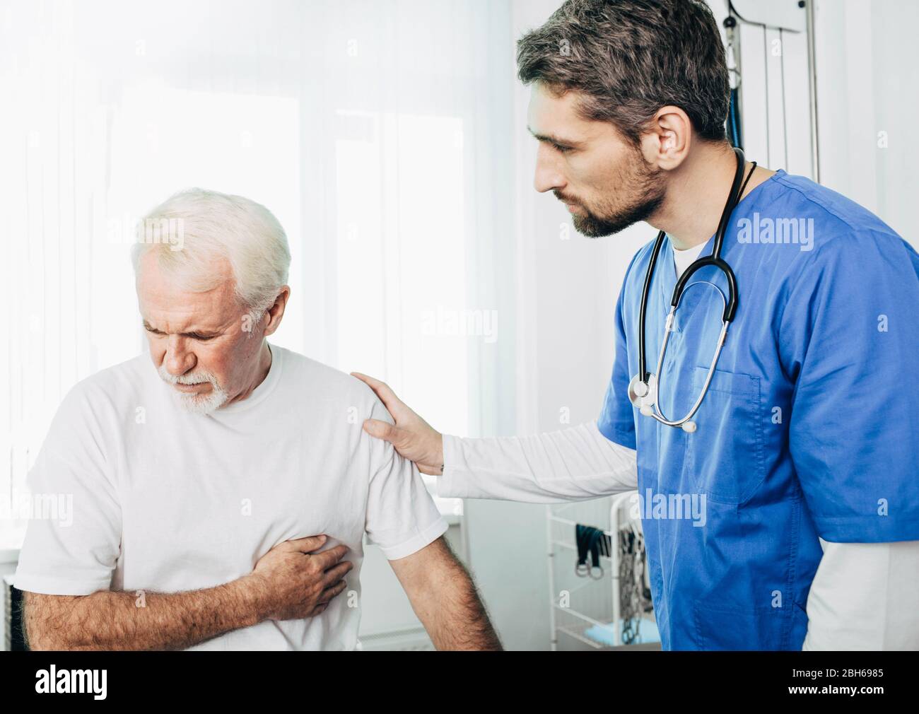 Senior patient suffering from heart attack . doctor care about patient ...