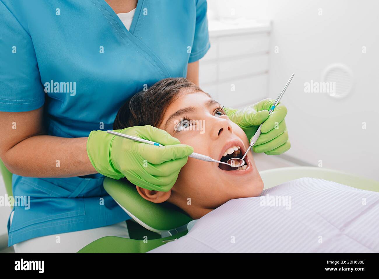 children's teeth exam. Close-up little boy having teeth exam at dental ...