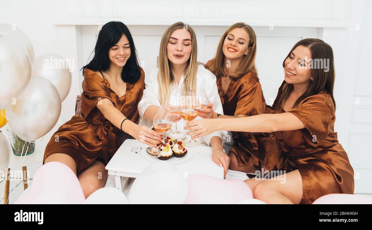 Pajamas party time. Beautiful charming girlfriends celebrating hen ...
