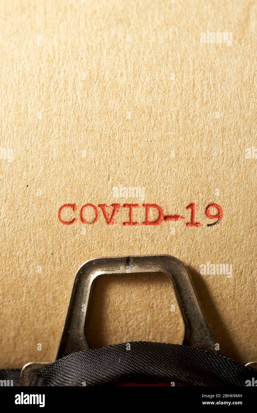 Covid-19 word written on a paper Stock Photo - Alamy