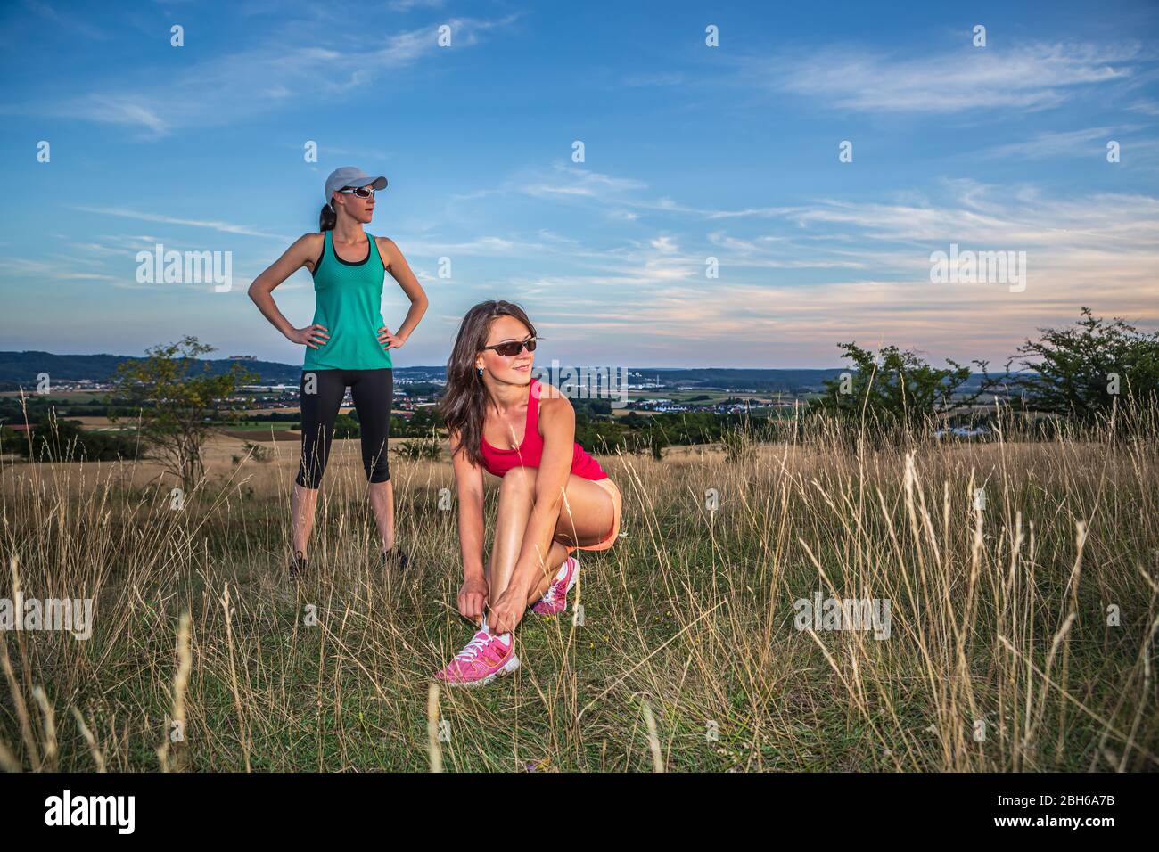 young women jogging in front of rural landscape Stock Photo - Alamy