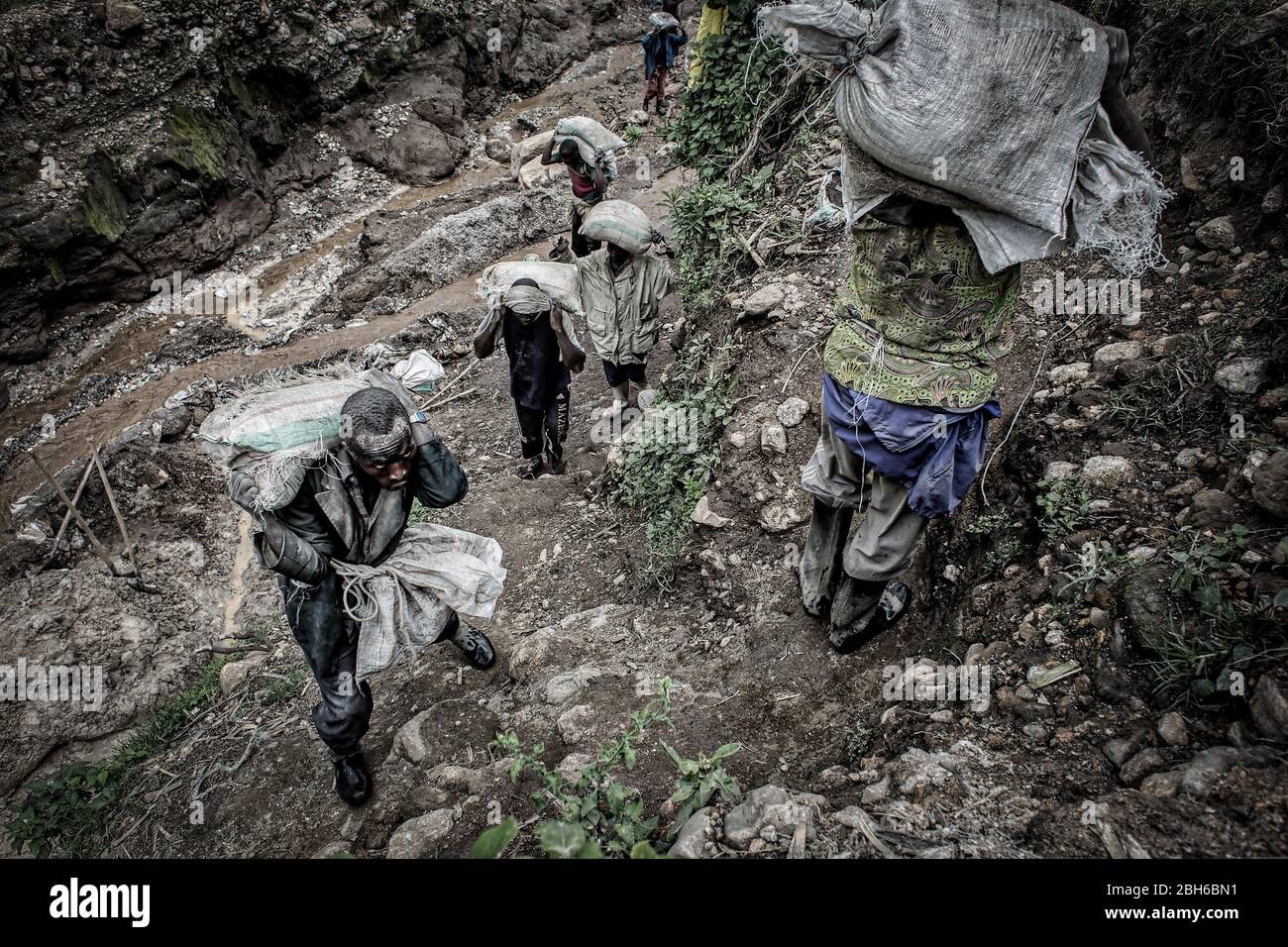 Coltan illegal mining in Democratic Republic of Congo. Miners carrying ...