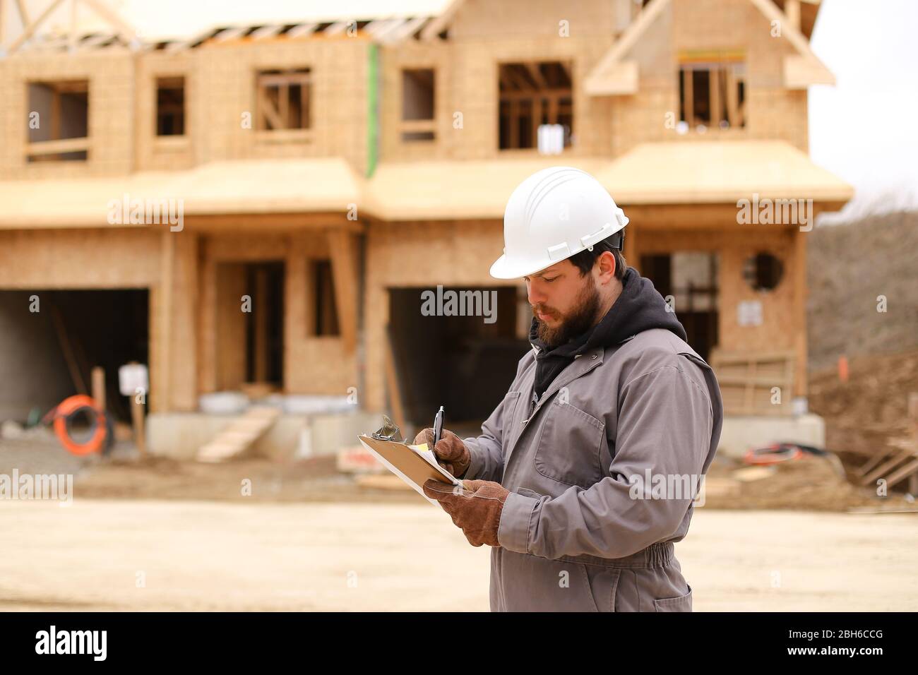Architect drawing plan in notebook at construction site Stock Photo - Alamy