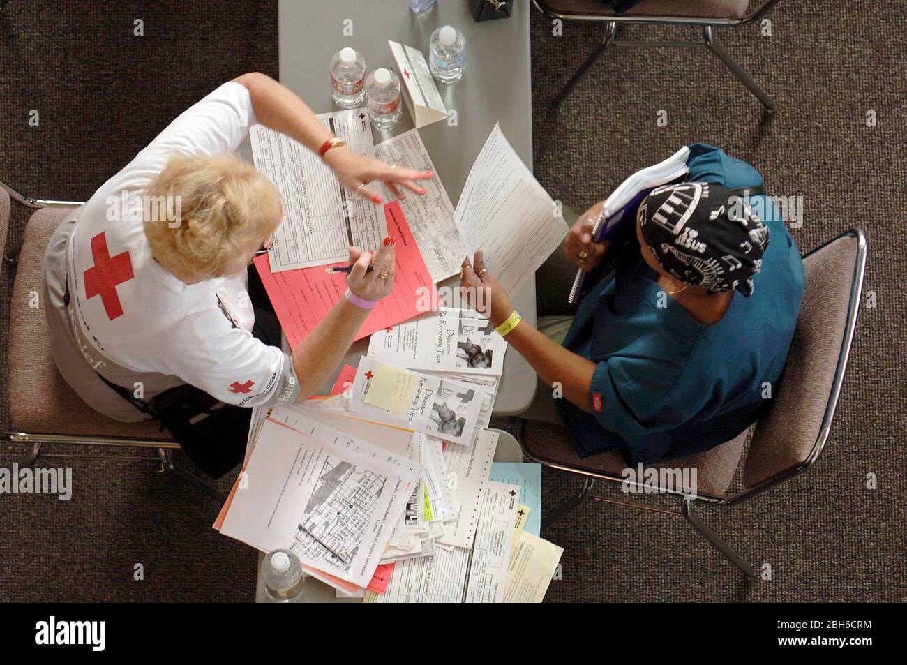 Black woman wading through government paperwork hi-res stock ...