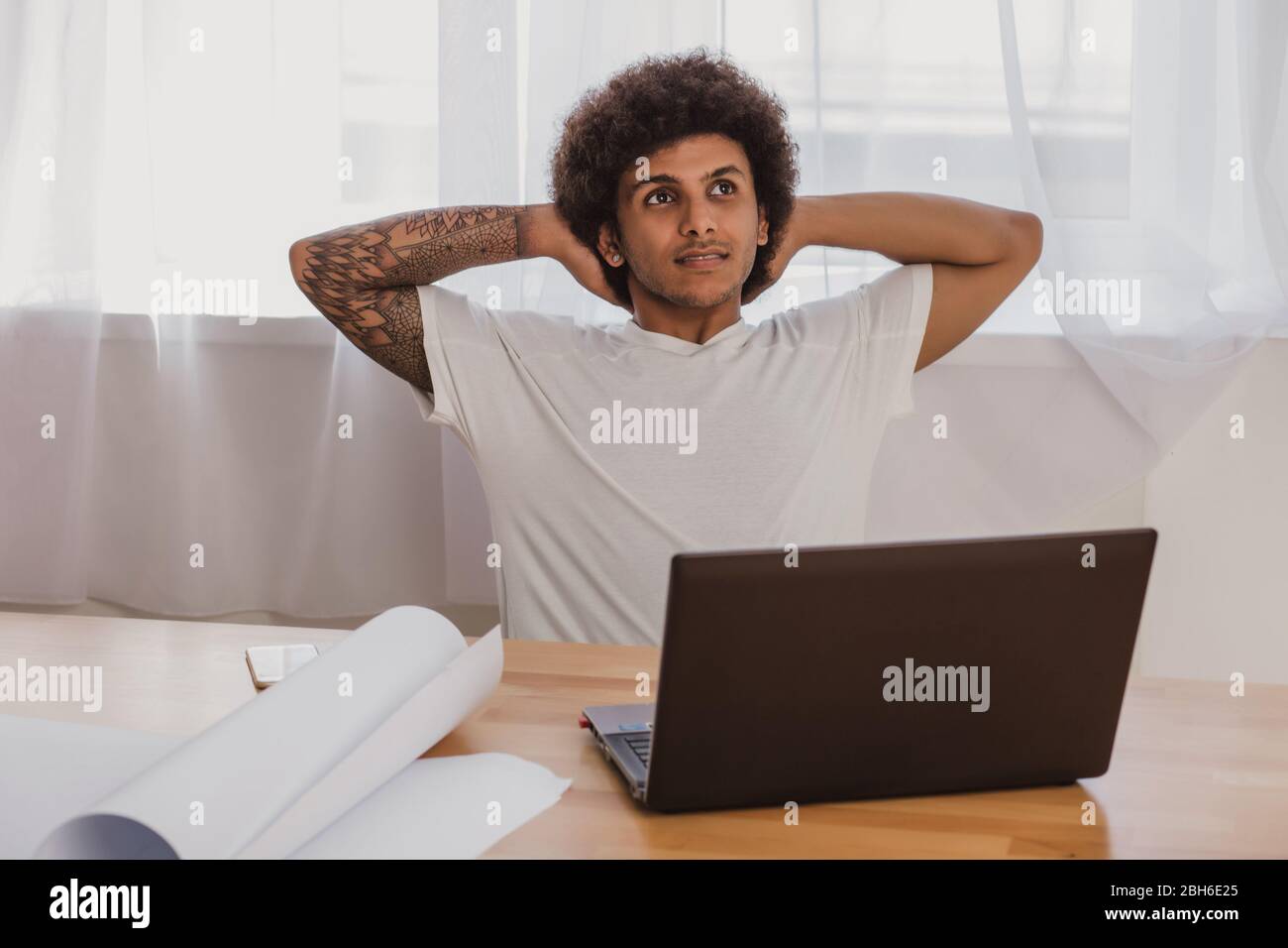 man architect , leaning Back On Chair while sitting at his working ...