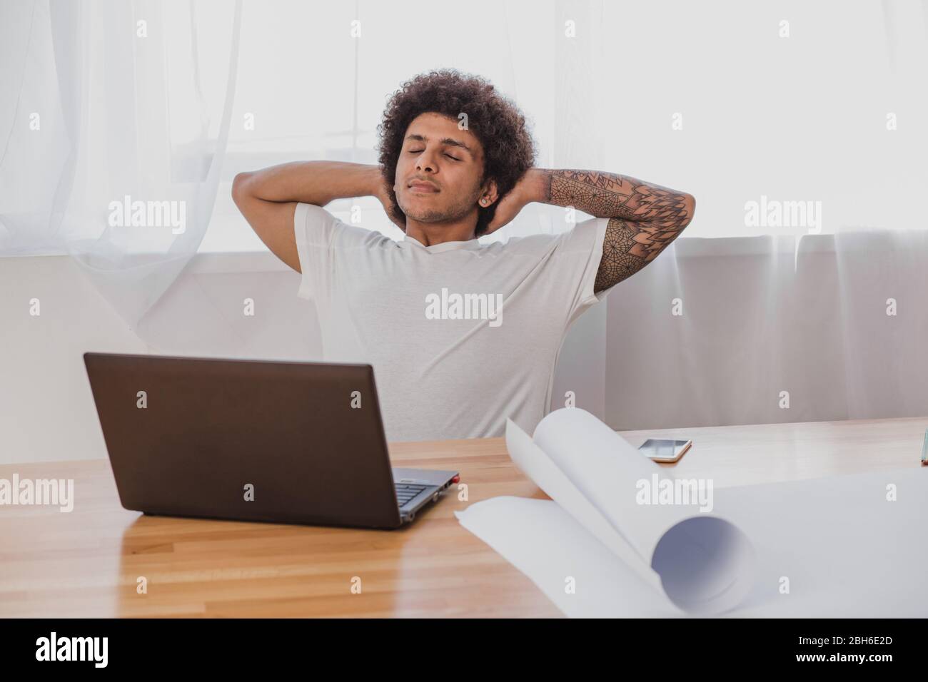 Time relax, after work done. Attractive man designer, leaning Back On ...