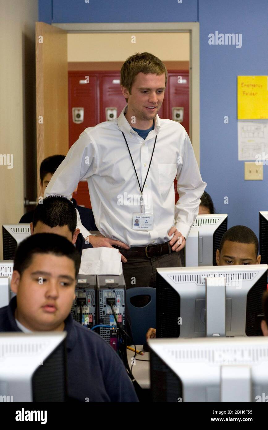 Dallas, Texas, January 23, 2009: Male teacher supervises seventh and eighth grade students in ...