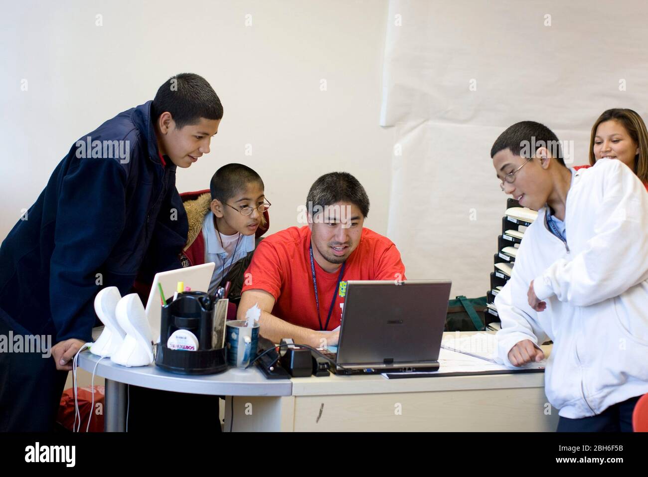Teens crowded around teacher hi-res stock photography and images - Alamy