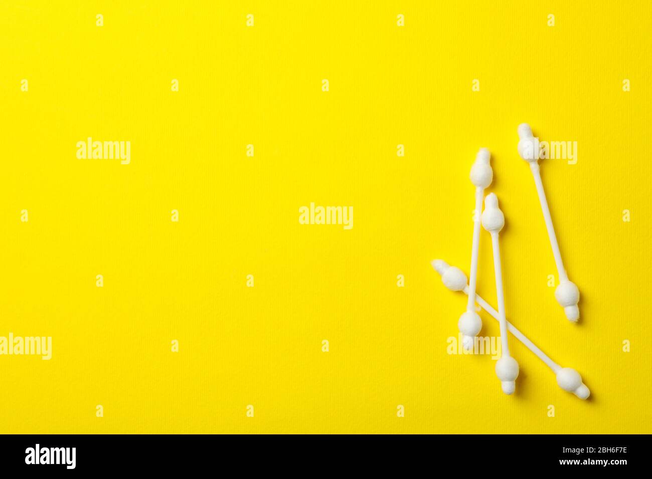 Baby ear sticks on yellow background. Hygiene Stock Photo - Alamy