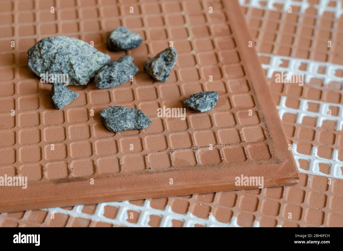 Ceramic tiles and crushed stone close-up. A detailed shot of a group of ...