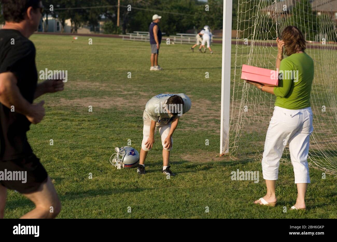 Austin, Texas USA, May 23, 2009: An exhausted youth football player ...