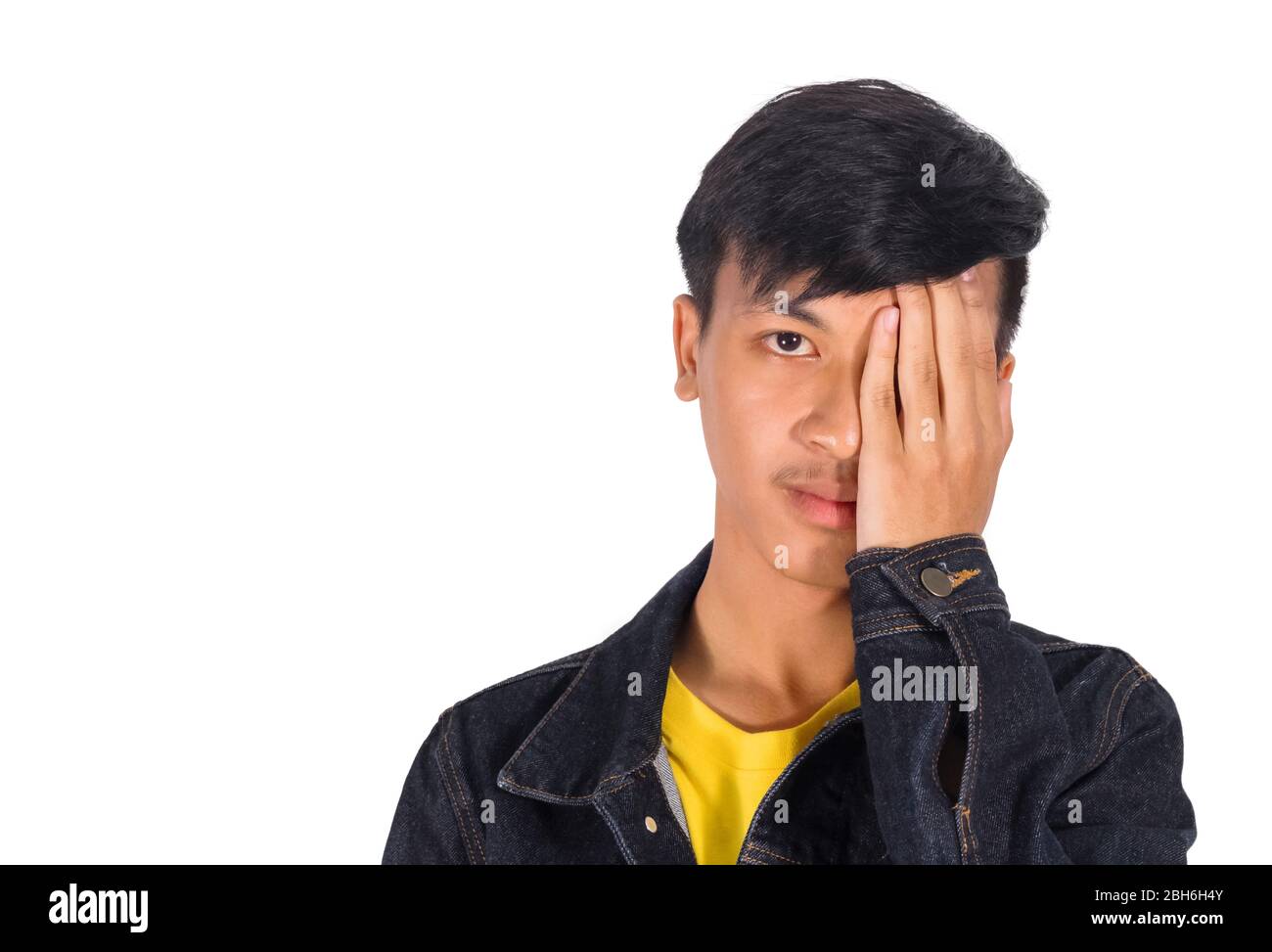 The photo of An Asianman is closing only one eye with his hand Stock ...