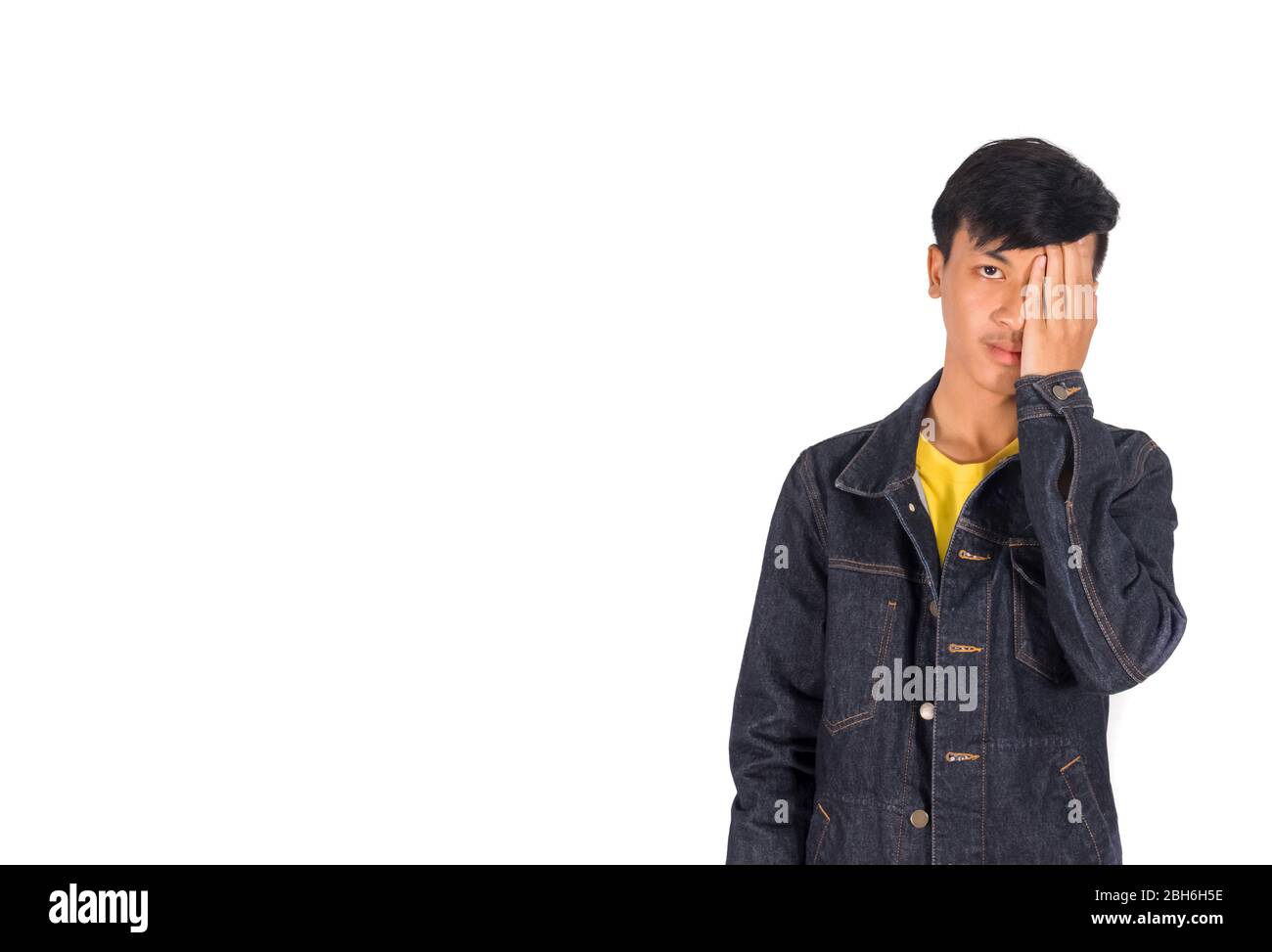 The photo of An Asianman is closing only one eye with his hand Stock ...