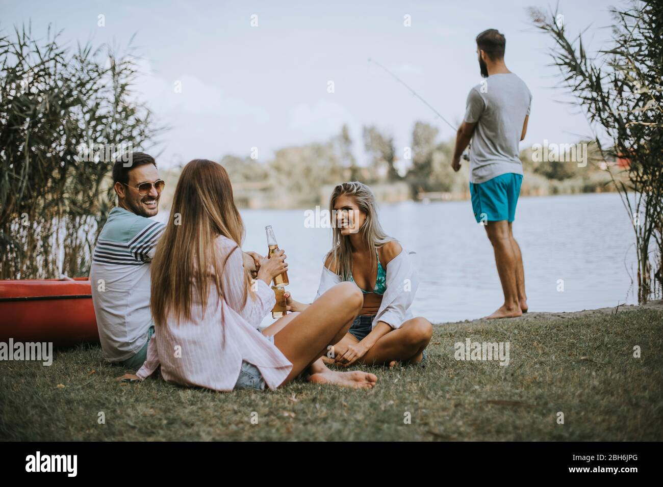 Group of happy young friends enjoying the nature on the lakeside Stock ...