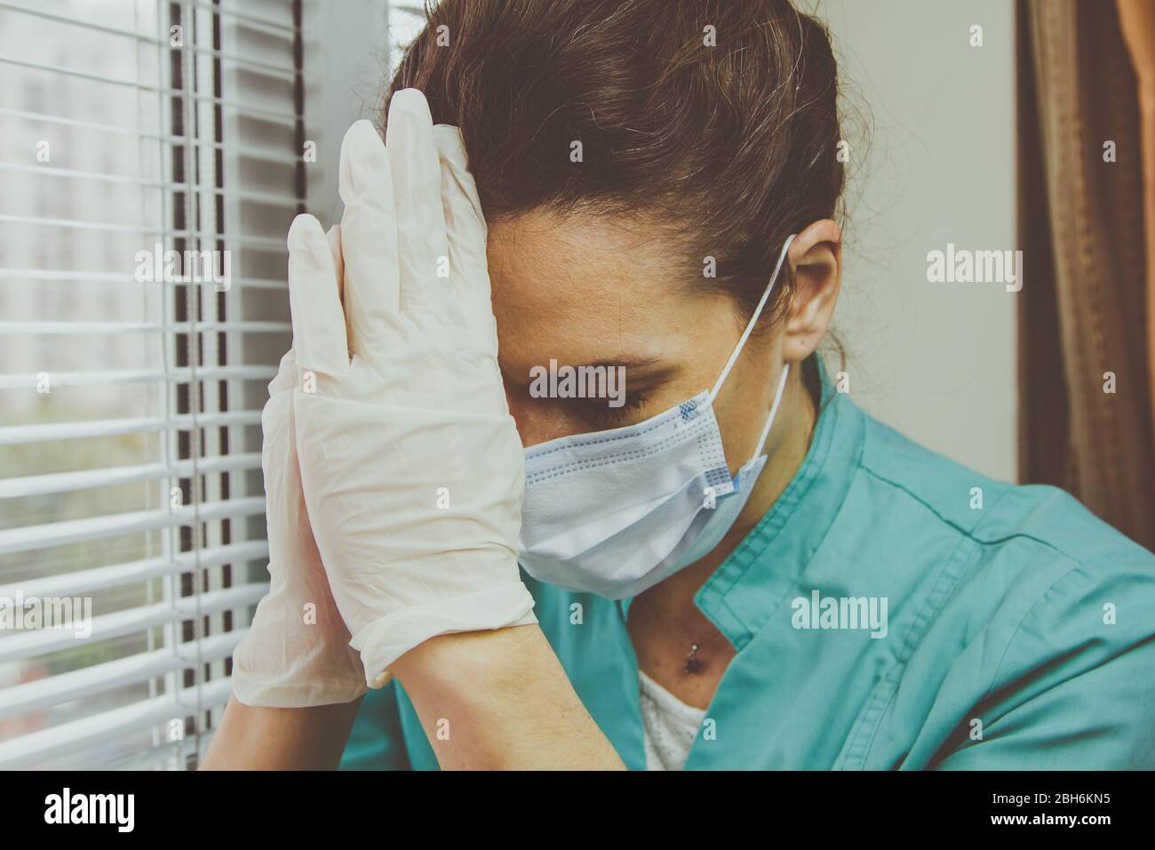 Portrait of Tired exhausted doctor with medical surgical mask on her ...