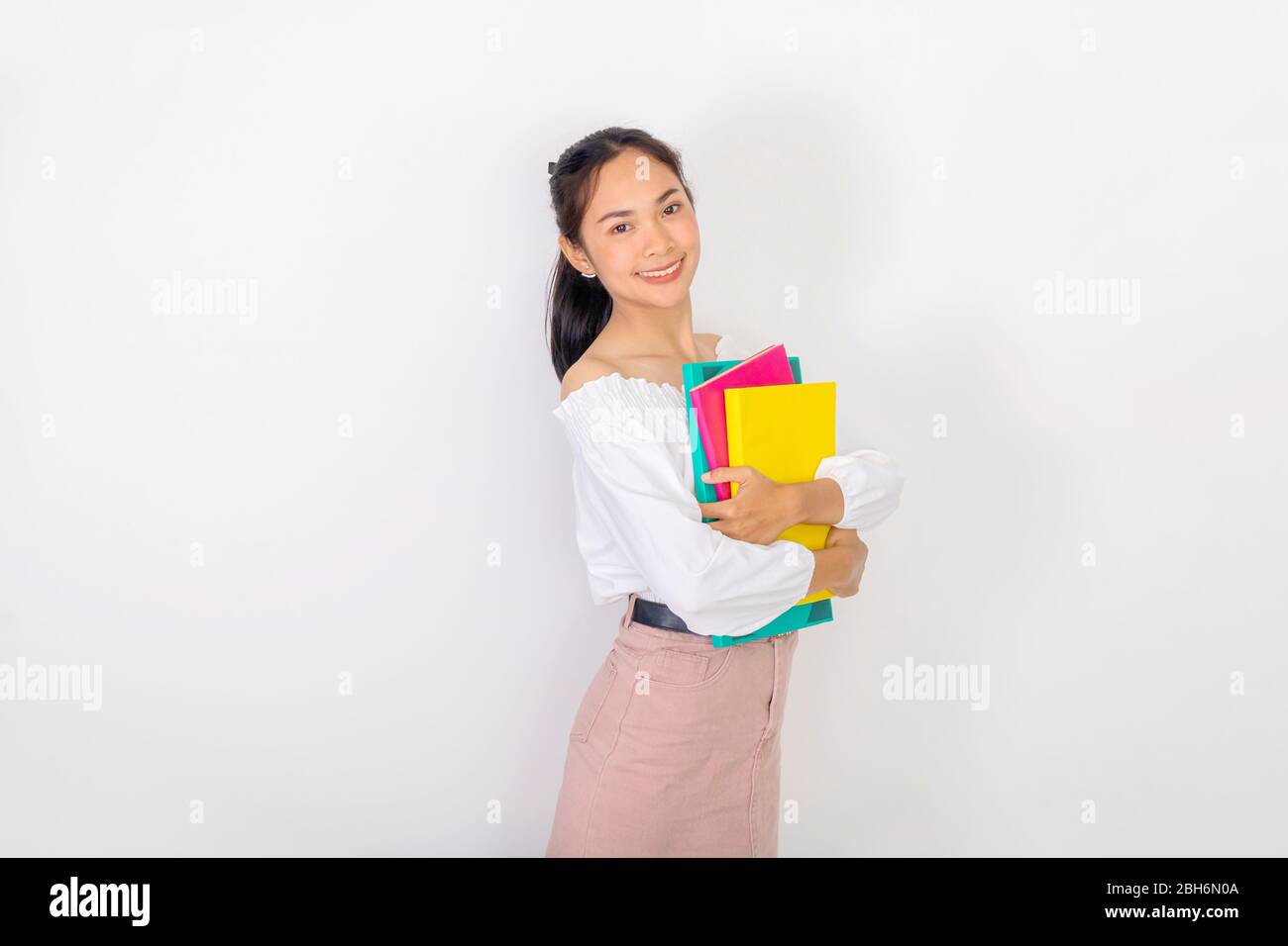 Woman holding book chest looking hi-res stock photography and images ...