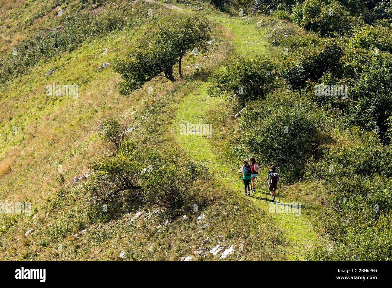 Hikers Walking On A Mountain Path Stock Photo - Alamy