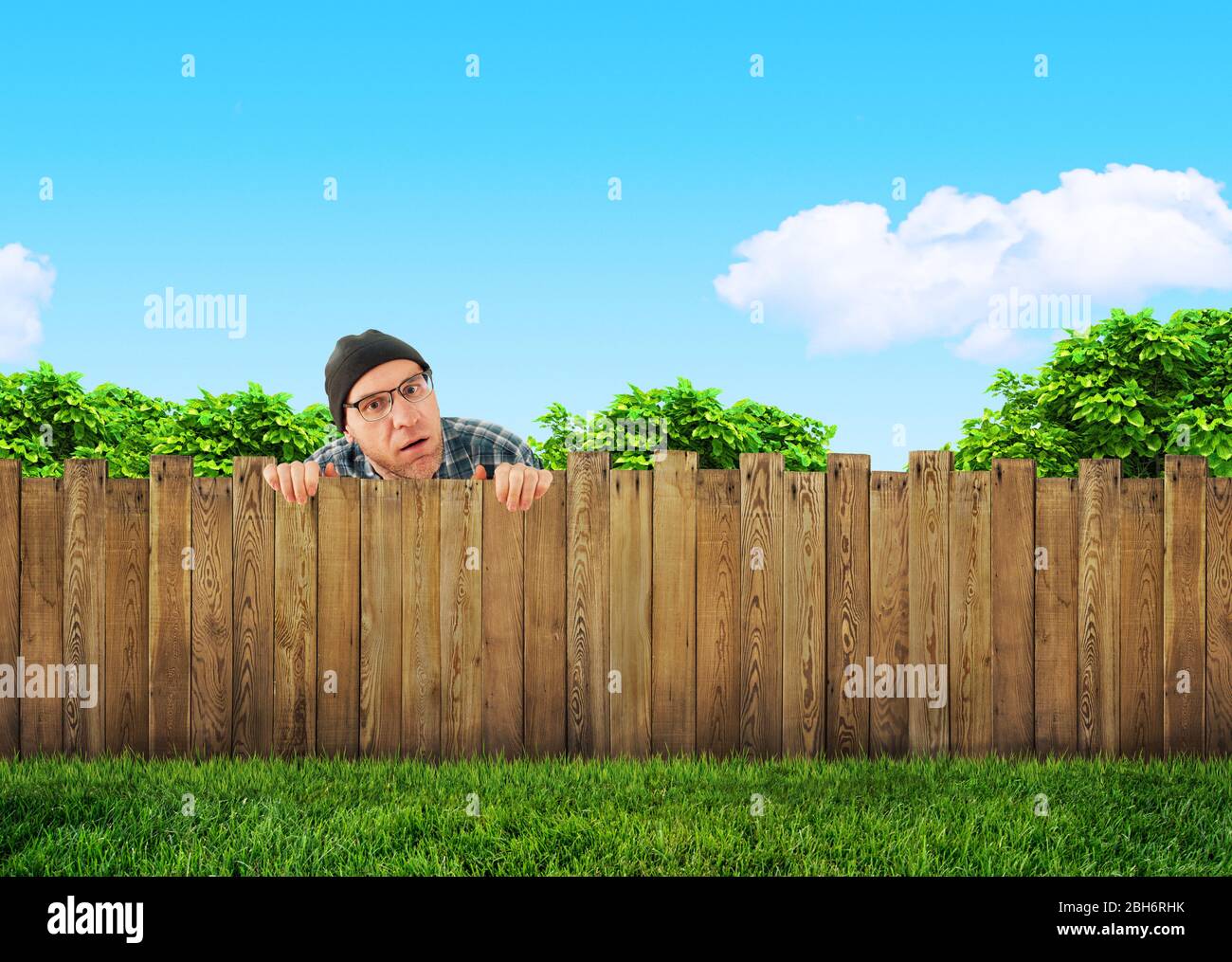 curious neighbor behind backyard fence Stock Photo - Alamy