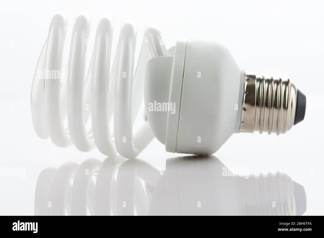 Fluorescent light bulb lay on white studio background Stock Photo - Alamy