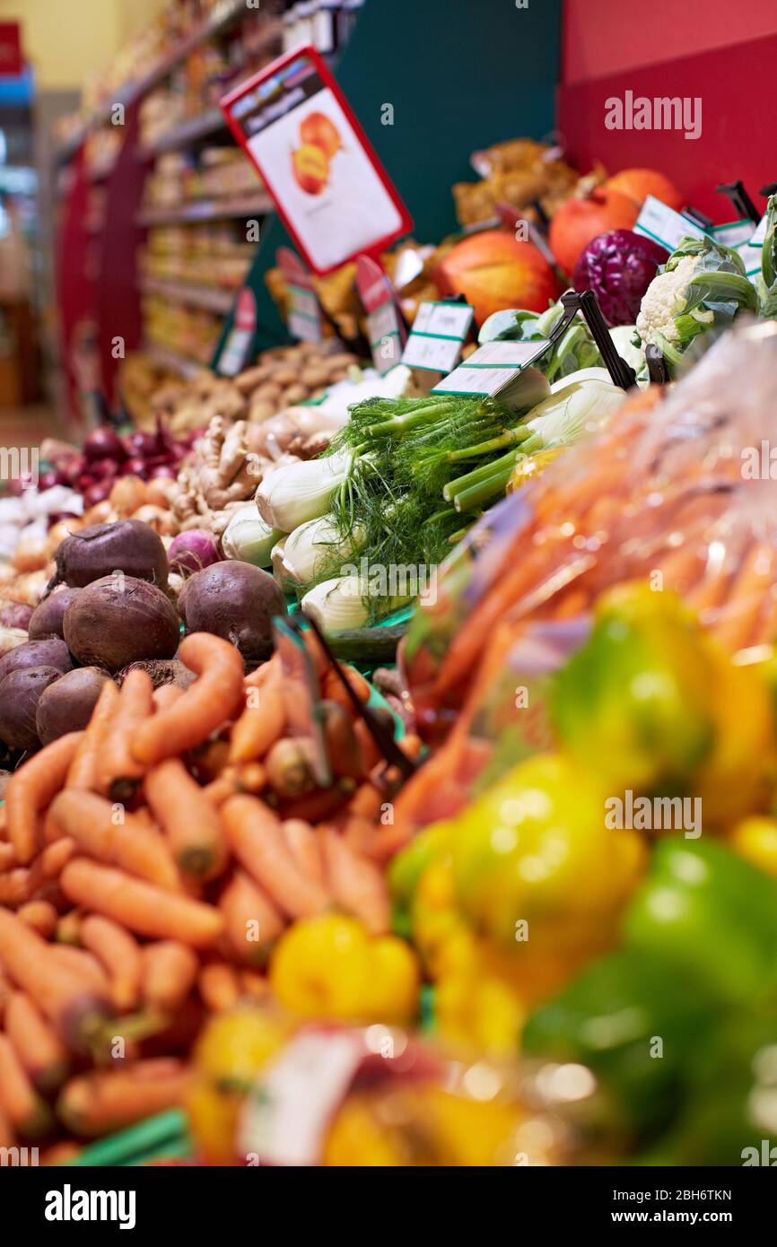 Filled vegetable counter with lots of vegetables in a health food store ...