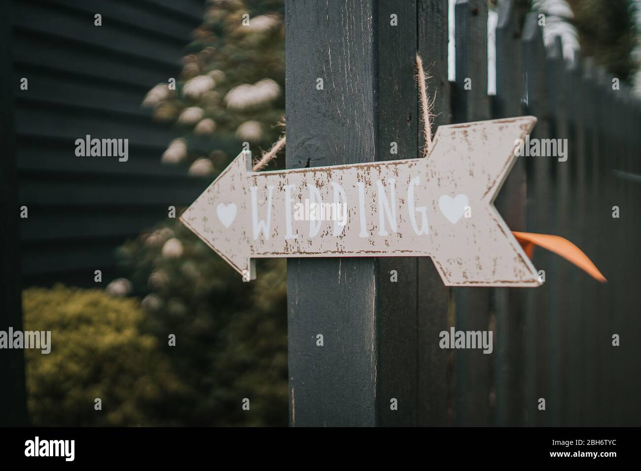 Wedding Arrow Sign hanging on a fence Stock Photo - Alamy