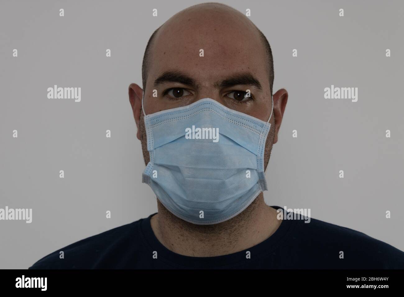 bald man with mask on white background Stock Photo - Alamy