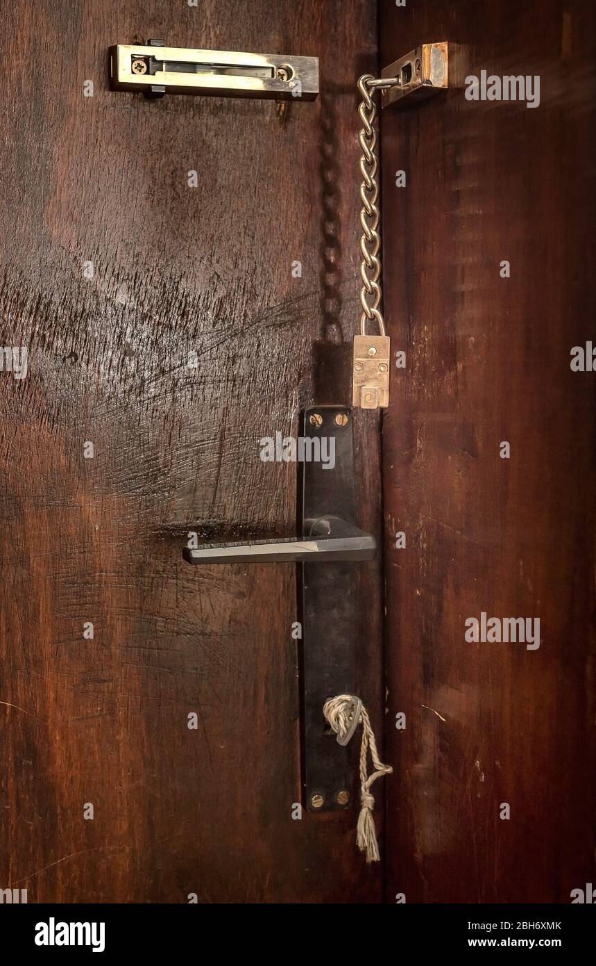 Old Wooden Door with Chain Lock, key in a keyhole and a door knob ...