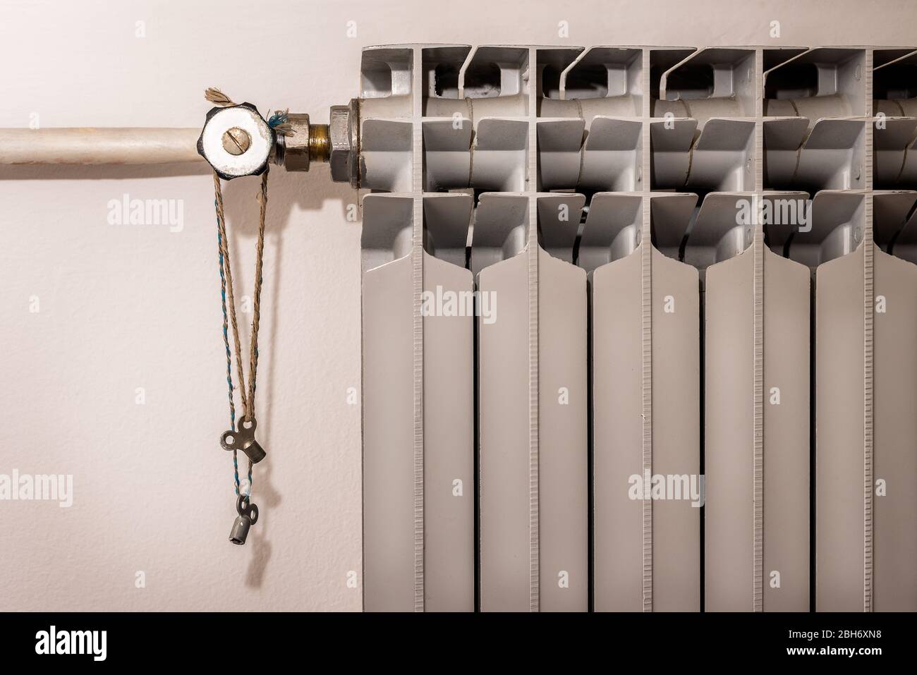 Close up heating radiator with Radiator Keys Brass Air Vent Clock Type ...