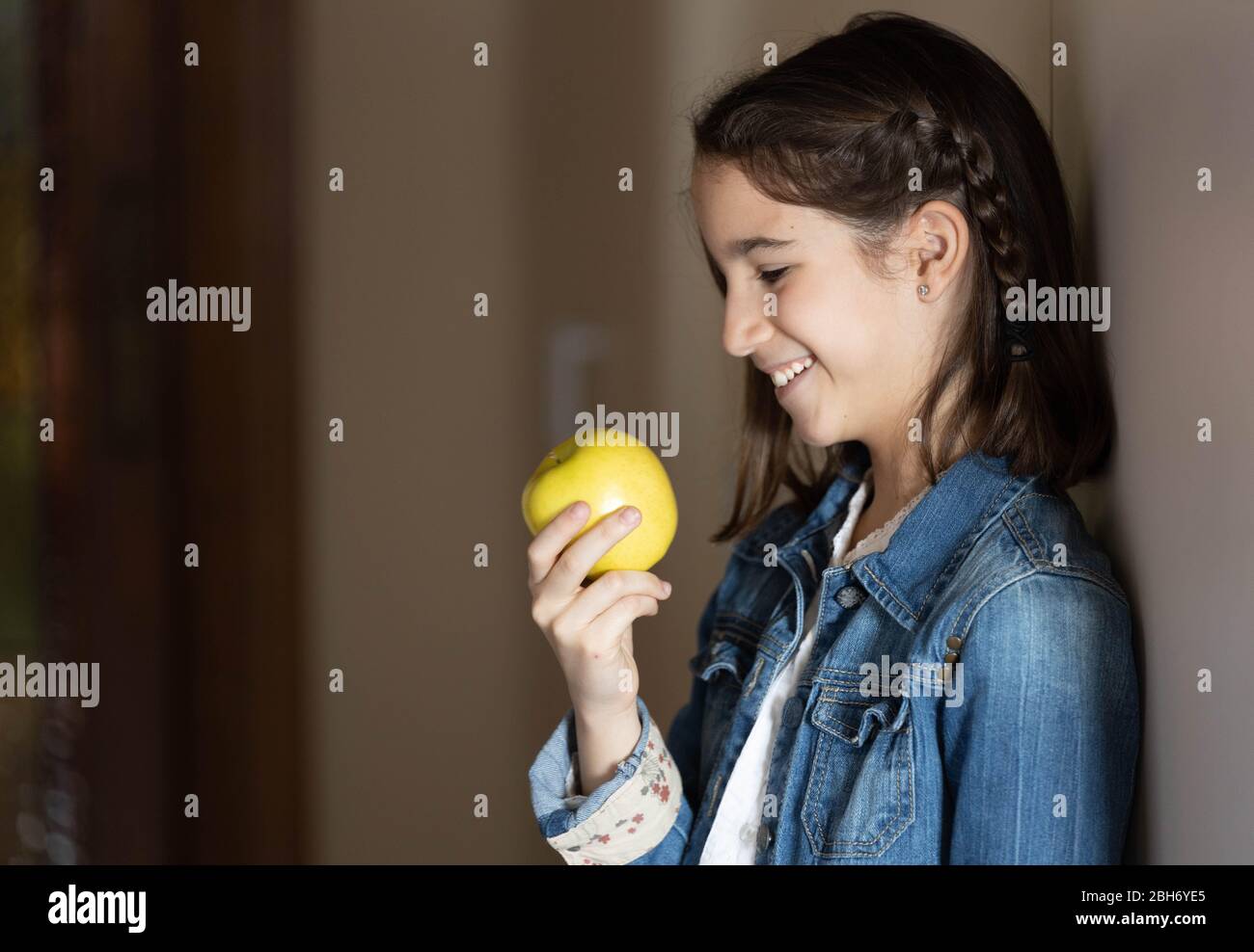 Little girl looking hungry at a golden apple she is holding Stock Photo ...