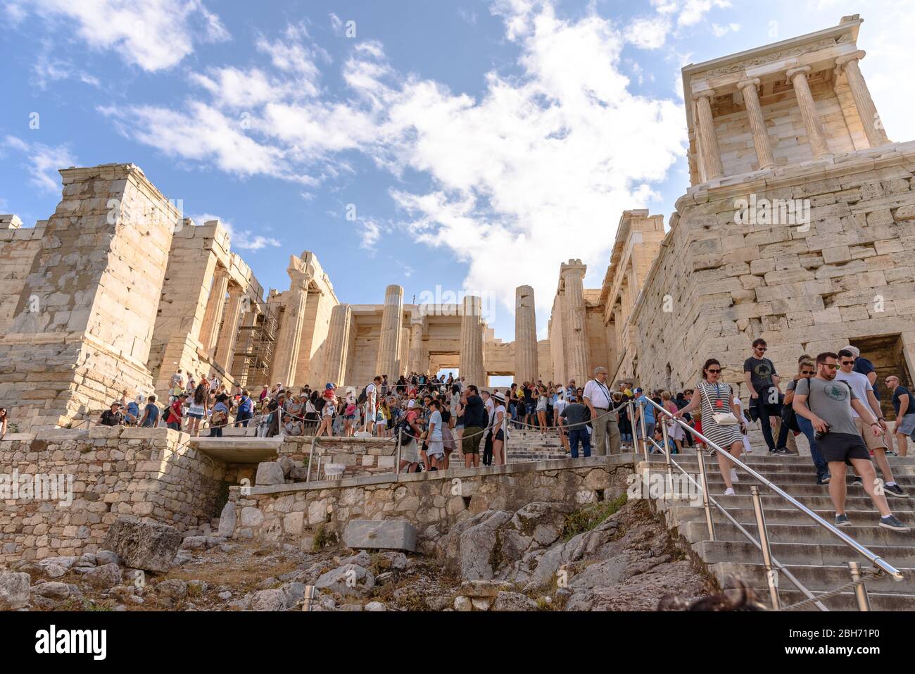 The Acropolis of Athens crowded with tourists on a sunny summer morning ...