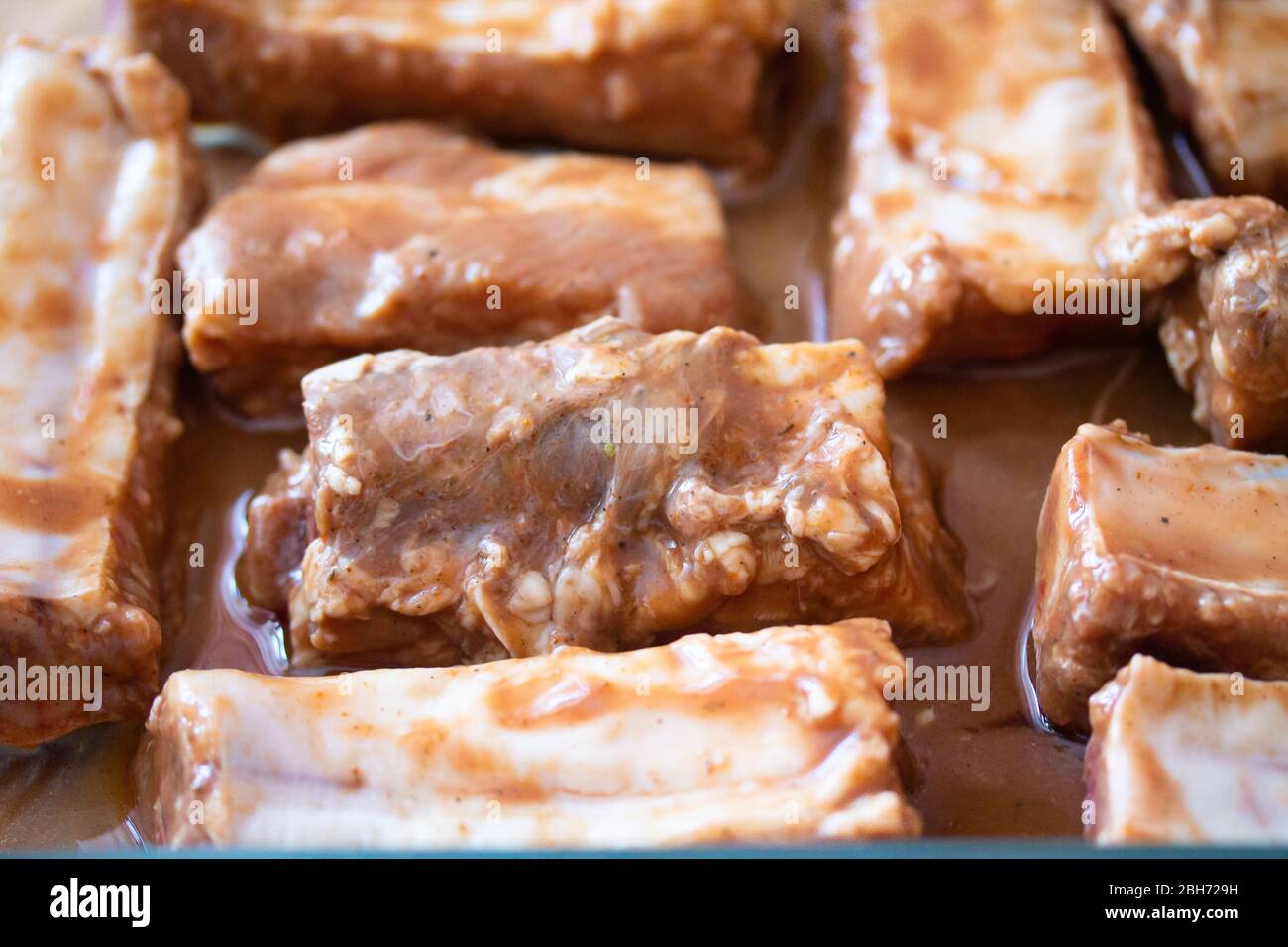 Raw marinaded juicy pork ribs ready for cooking. Meat processing ...