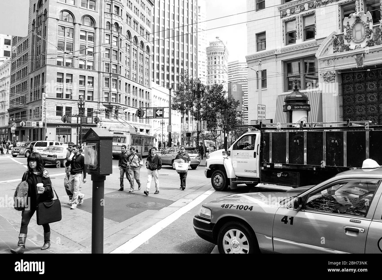People crossing the road in San Francisco USA walkers shopping Taxi cab ...